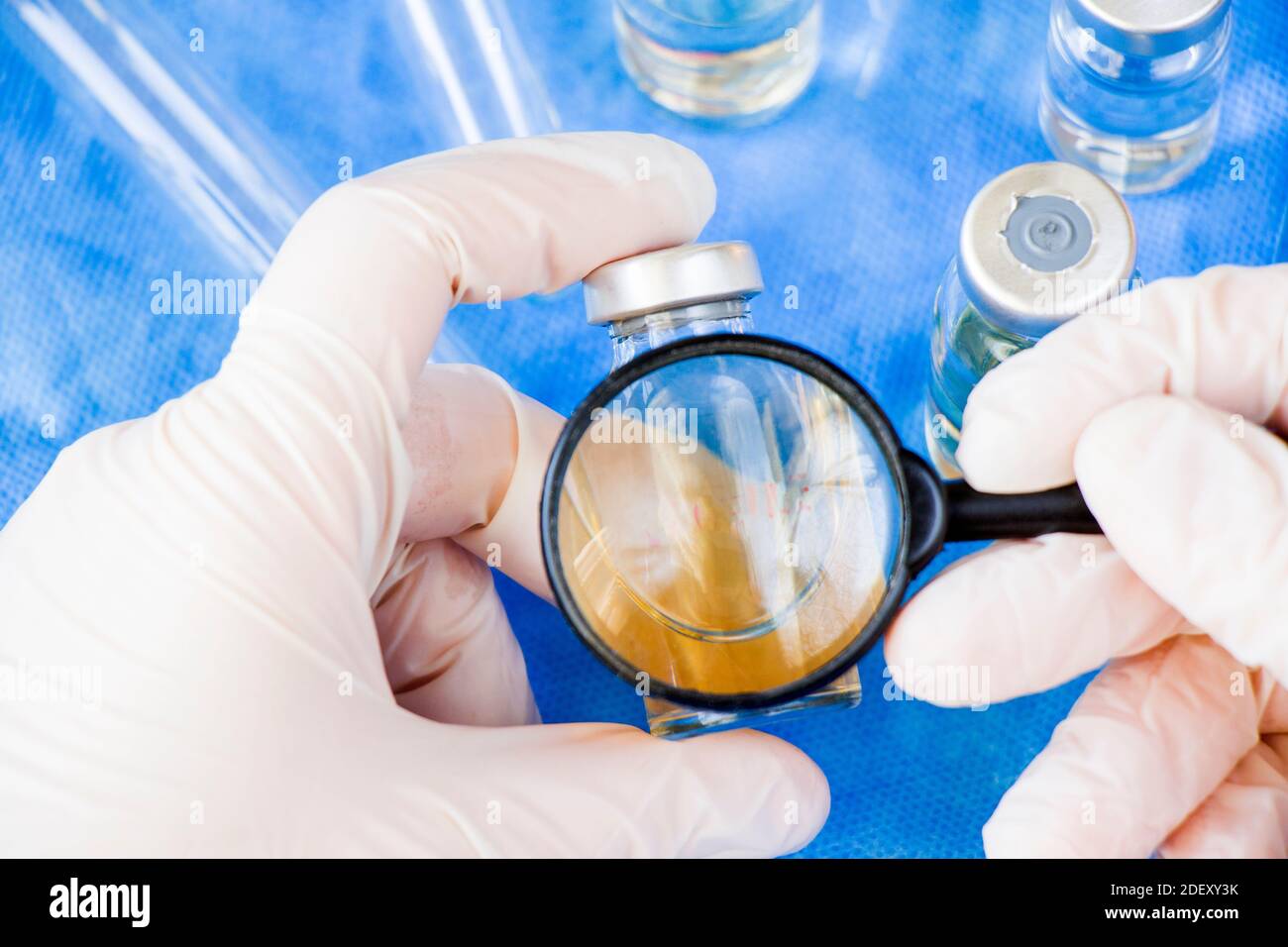 Magnifying glass and doctor's hands with glove, looking and research ...