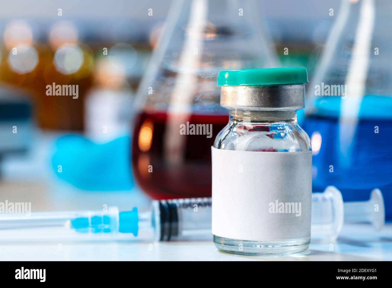 Vial of vaccine bottle with a syringe close up Stock Photo - Alamy