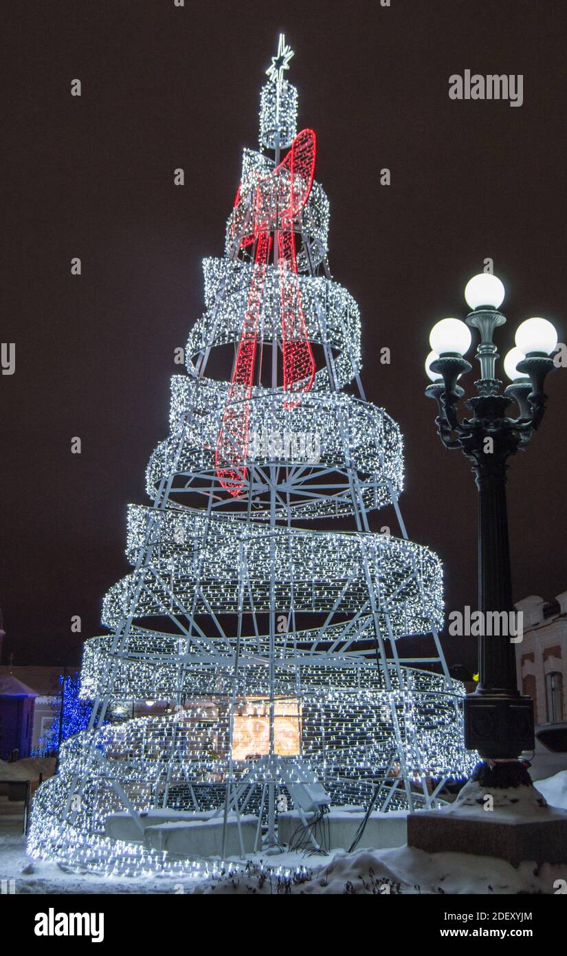 Festive creative Christmas tree made of metal construction with glowing ...
