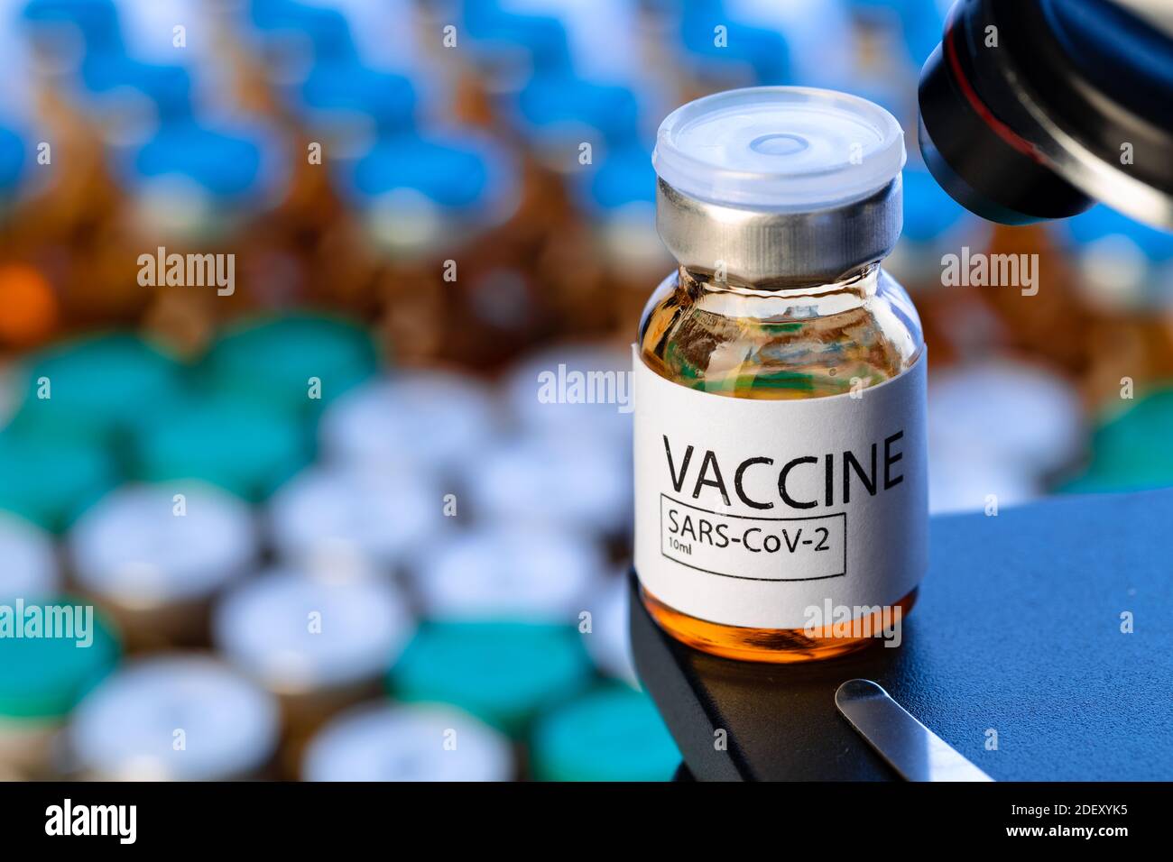 Vial of Covid-19 vaccine next to a microscope Stock Photo - Alamy