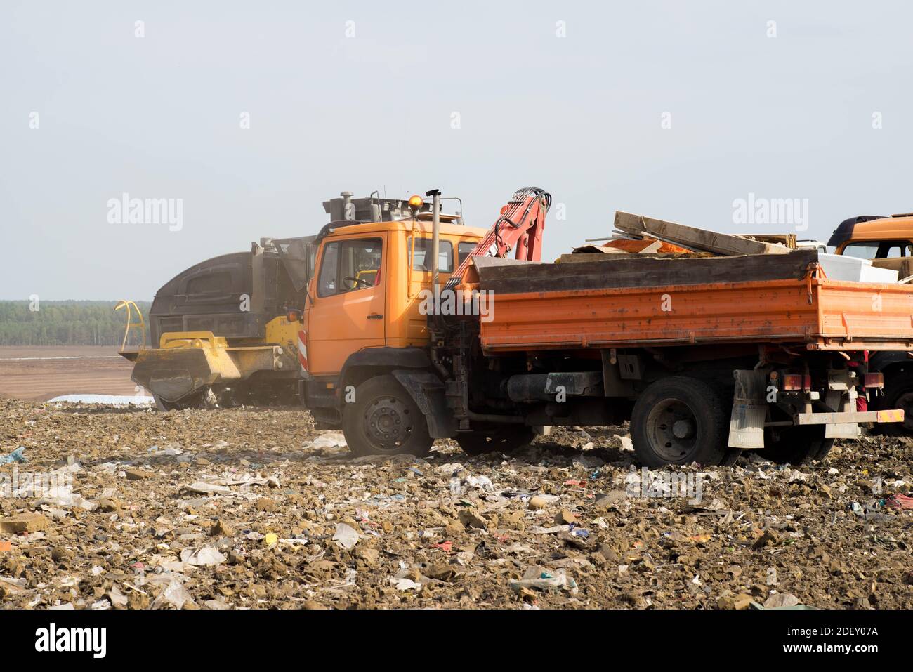 Waste sorting on landfill of big city. A lot of garbage. Truck with ...