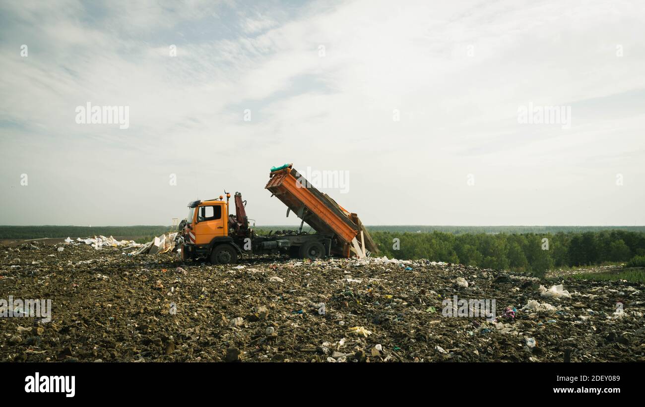 Huge dump of big city. Waste sorting on landfill. Truck unloading ...