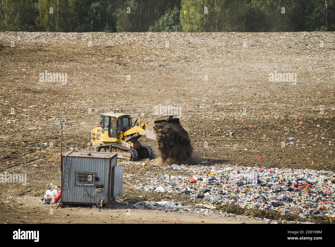 Huge dump of big city near forest. Tractor loader. Waste sorting ...