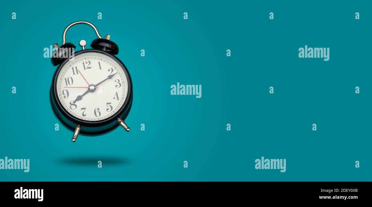 Black color clock hanging on banner template with space Stock Photo - Alamy