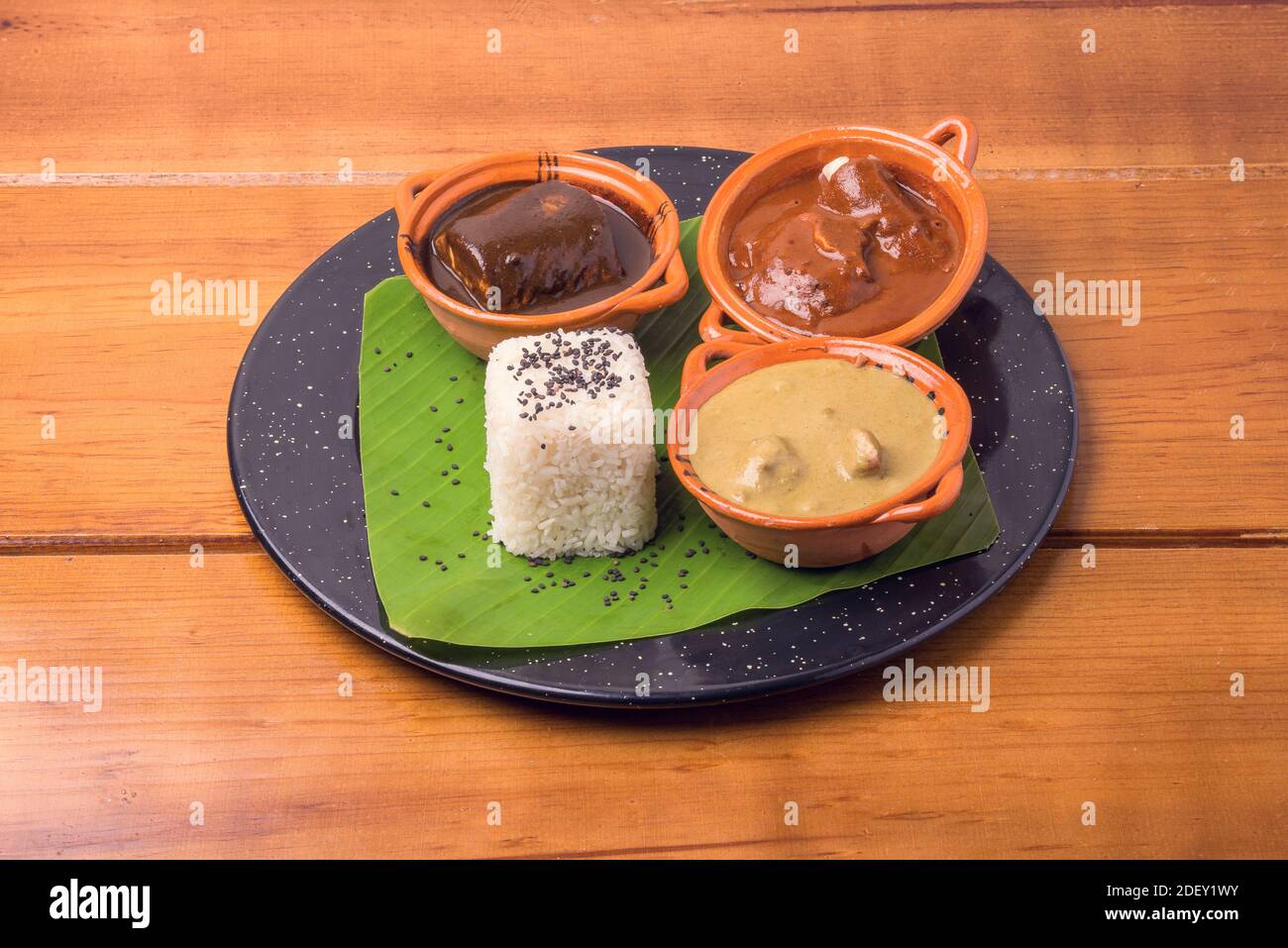A closeup of a gourmet Mexican food three types of mole with rice on a ...