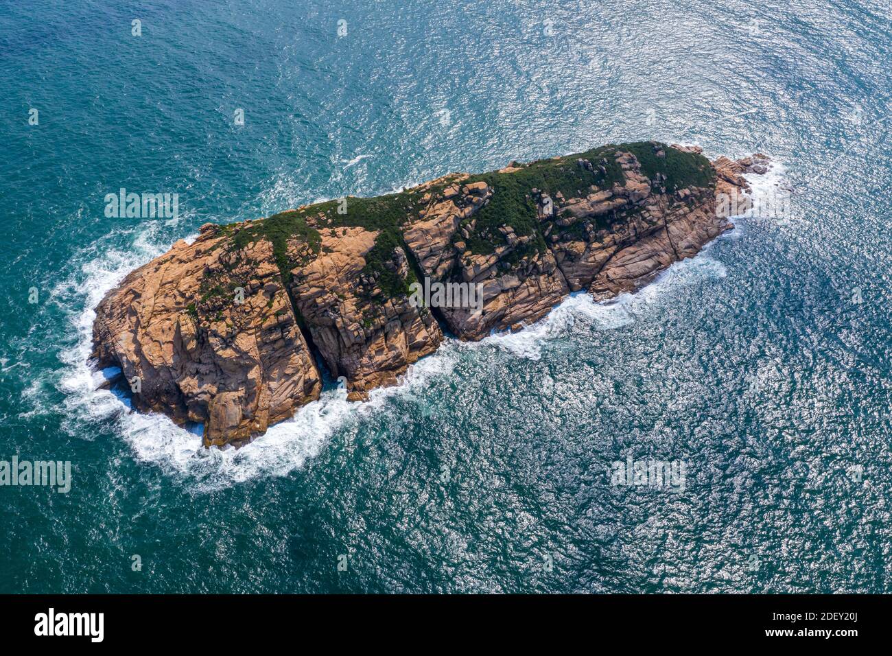 Aerial view of tiny rocky island in sea Stock Photo - Alamy