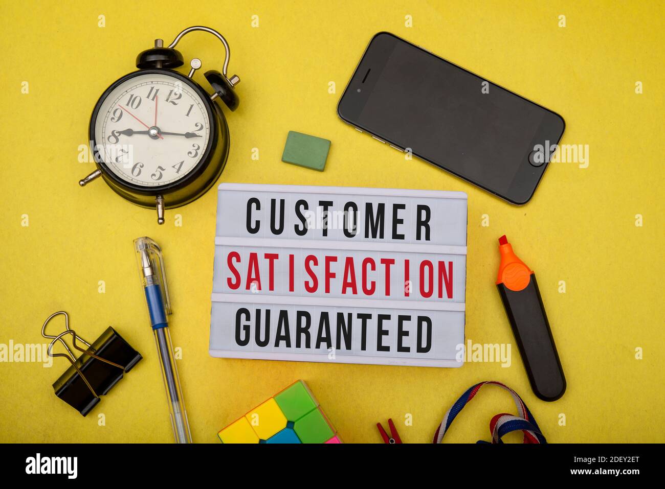 Customer Satisfaction guaranteed sign on office table top view Stock ...