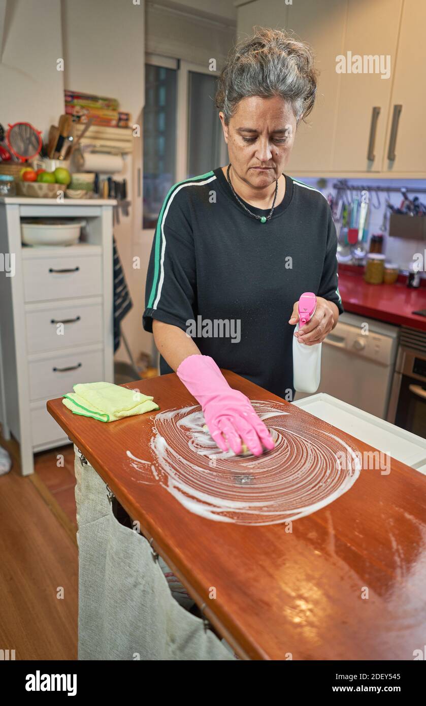 A vertical selective focus closeup of a female cleaning the kitchen ...