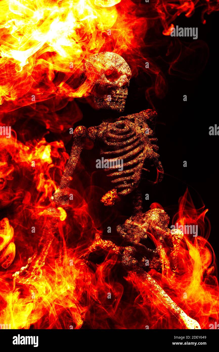 Scary demon Halloween skeleton dances in deadly fire Stock Photo - Alamy