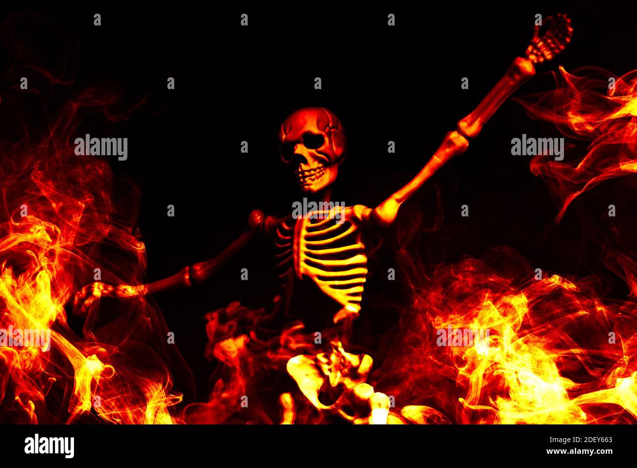 Scary demon Halloween skeleton dances in deadly fire Stock Photo - Alamy