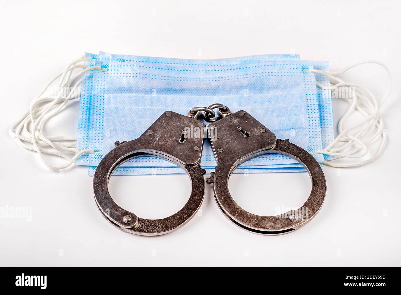 Medical Flu Mask and Handcuffs on the White Background closeup Stock ...