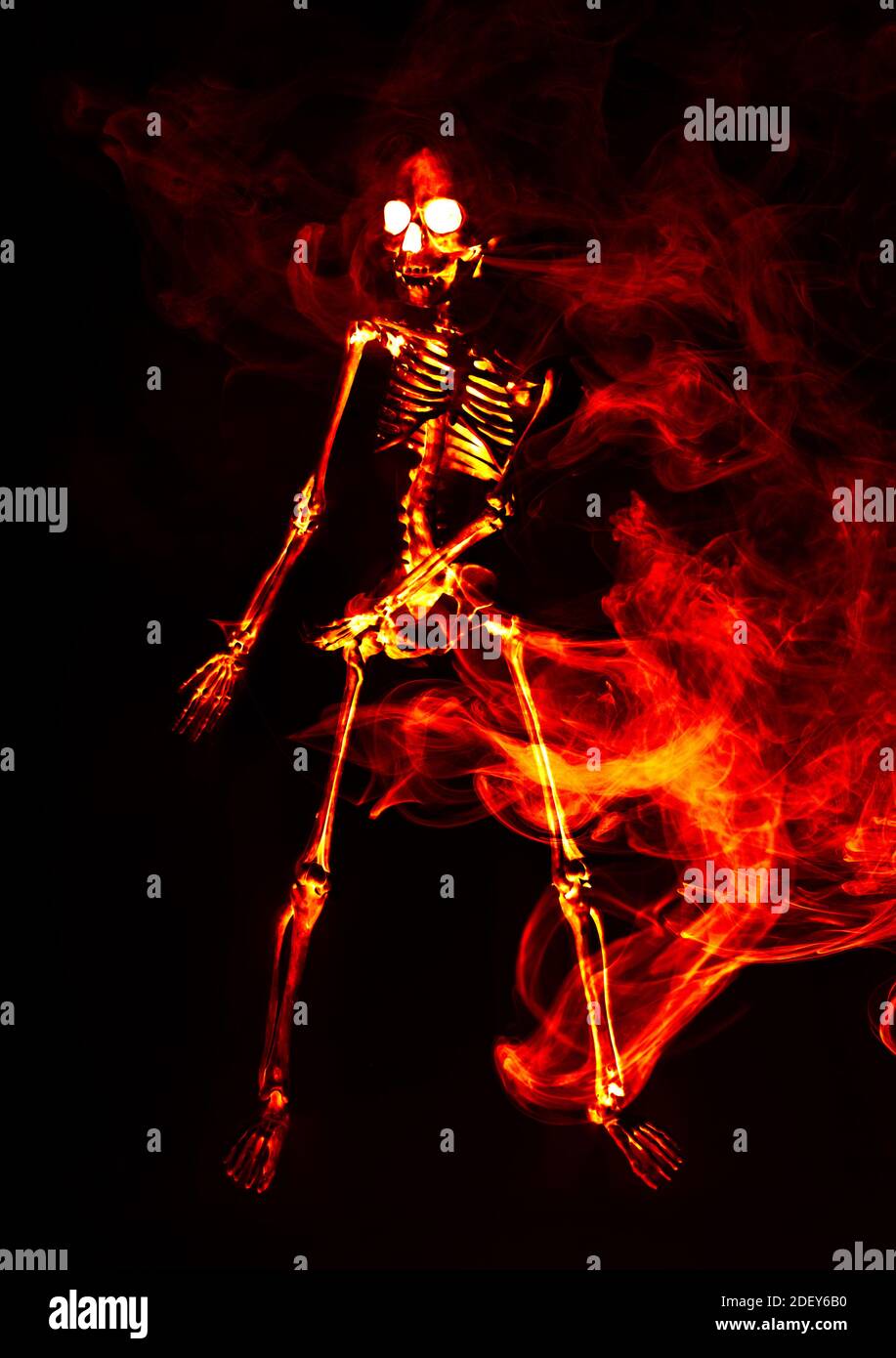 Scary demon Halloween skeleton dances in deadly fire Stock Photo - Alamy