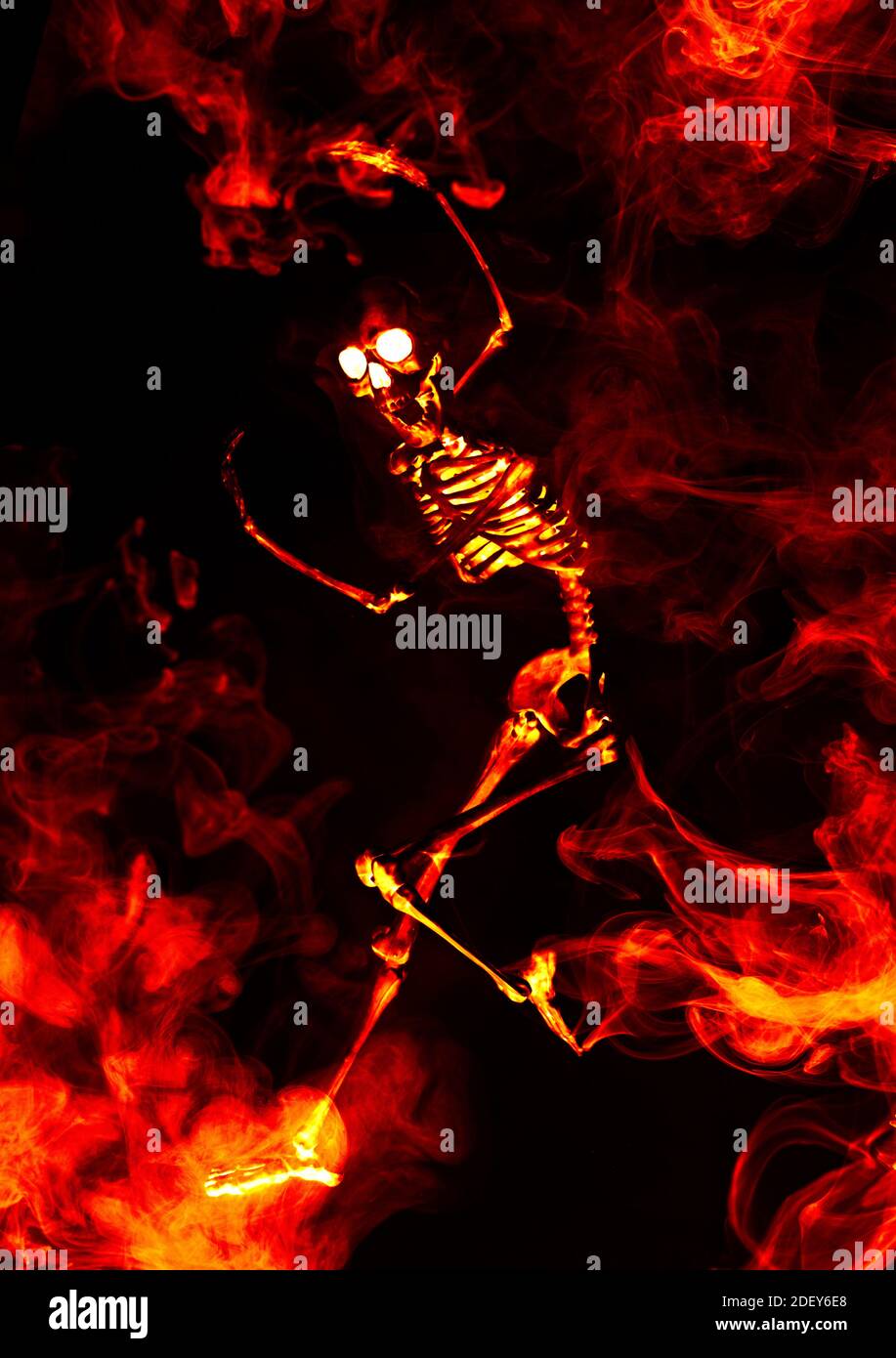 Scary demon Halloween skeleton dances in deadly fire Stock Photo - Alamy