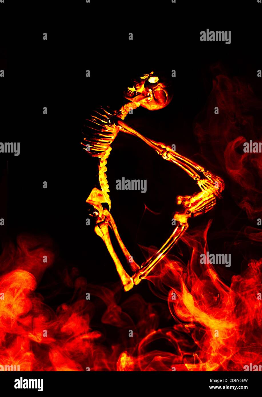 Scary demon Halloween skeleton dances in deadly fire Stock Photo - Alamy