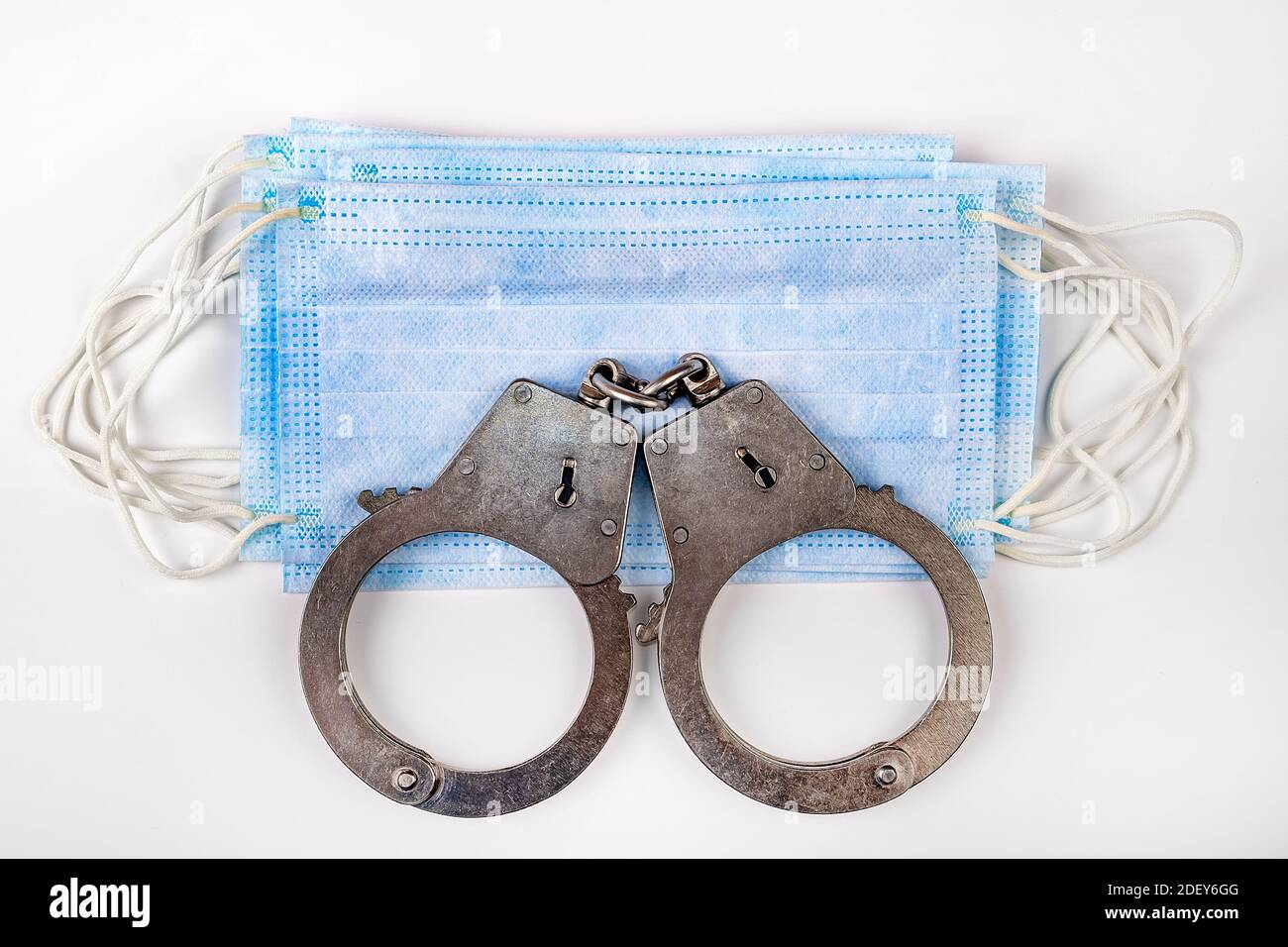 Medical Flu Mask and Handcuffs on the White Background closeup Stock ...