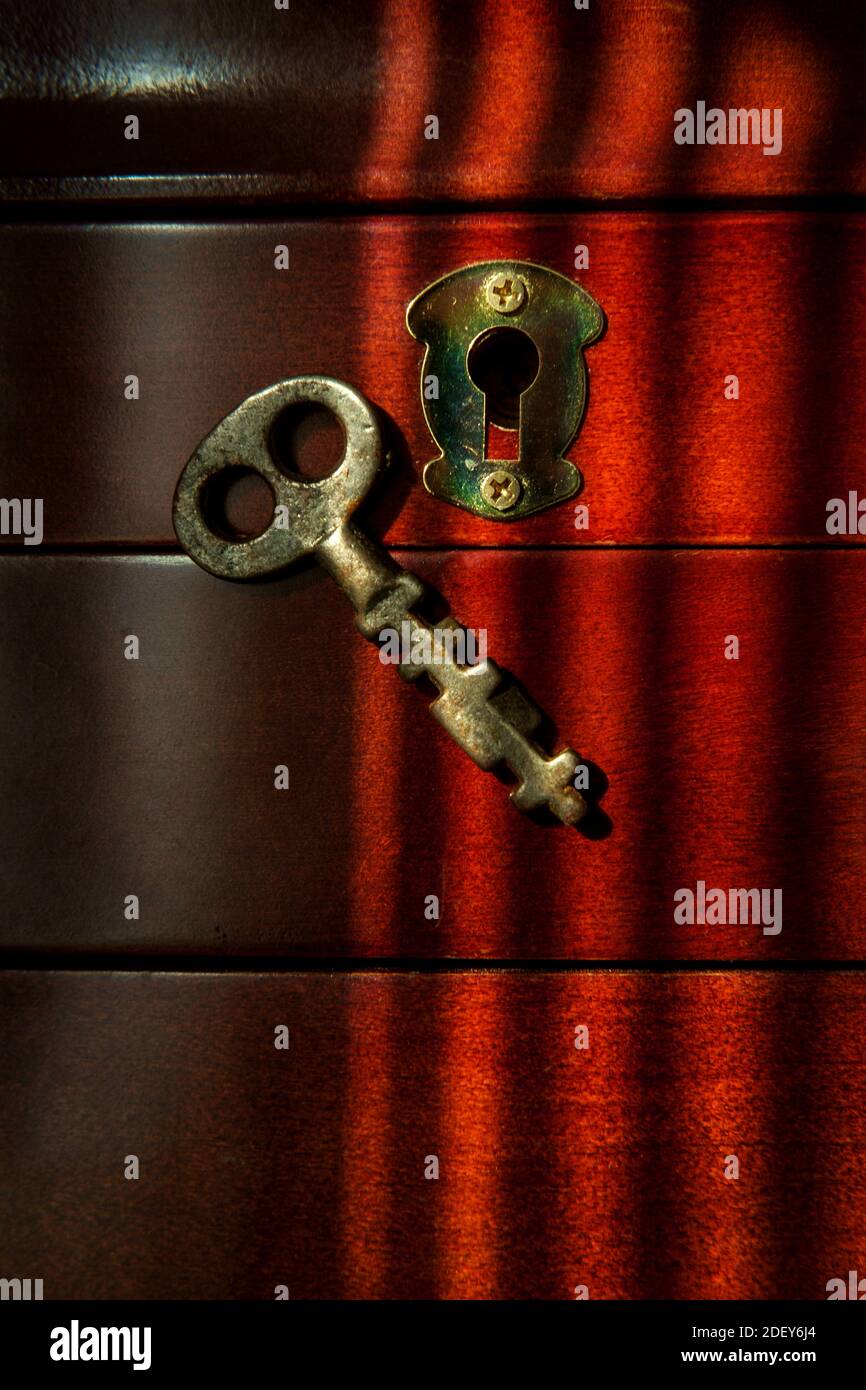 Old antique skeleton key on distressed textured wooden background Stock ...