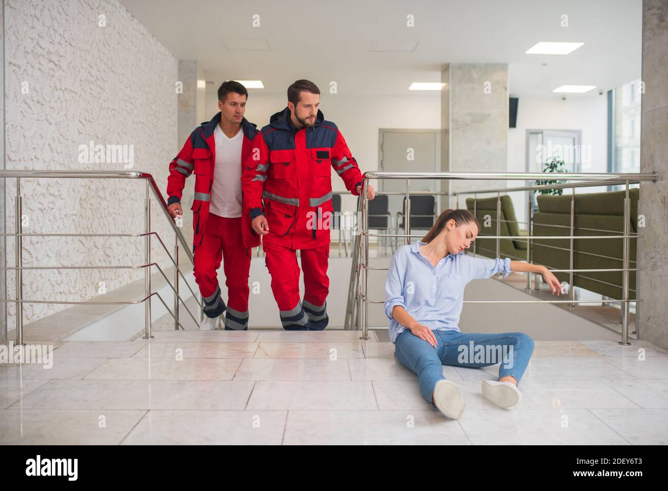 Ambulance crew giving first aid to the faint woman Stock Photo - Alamy