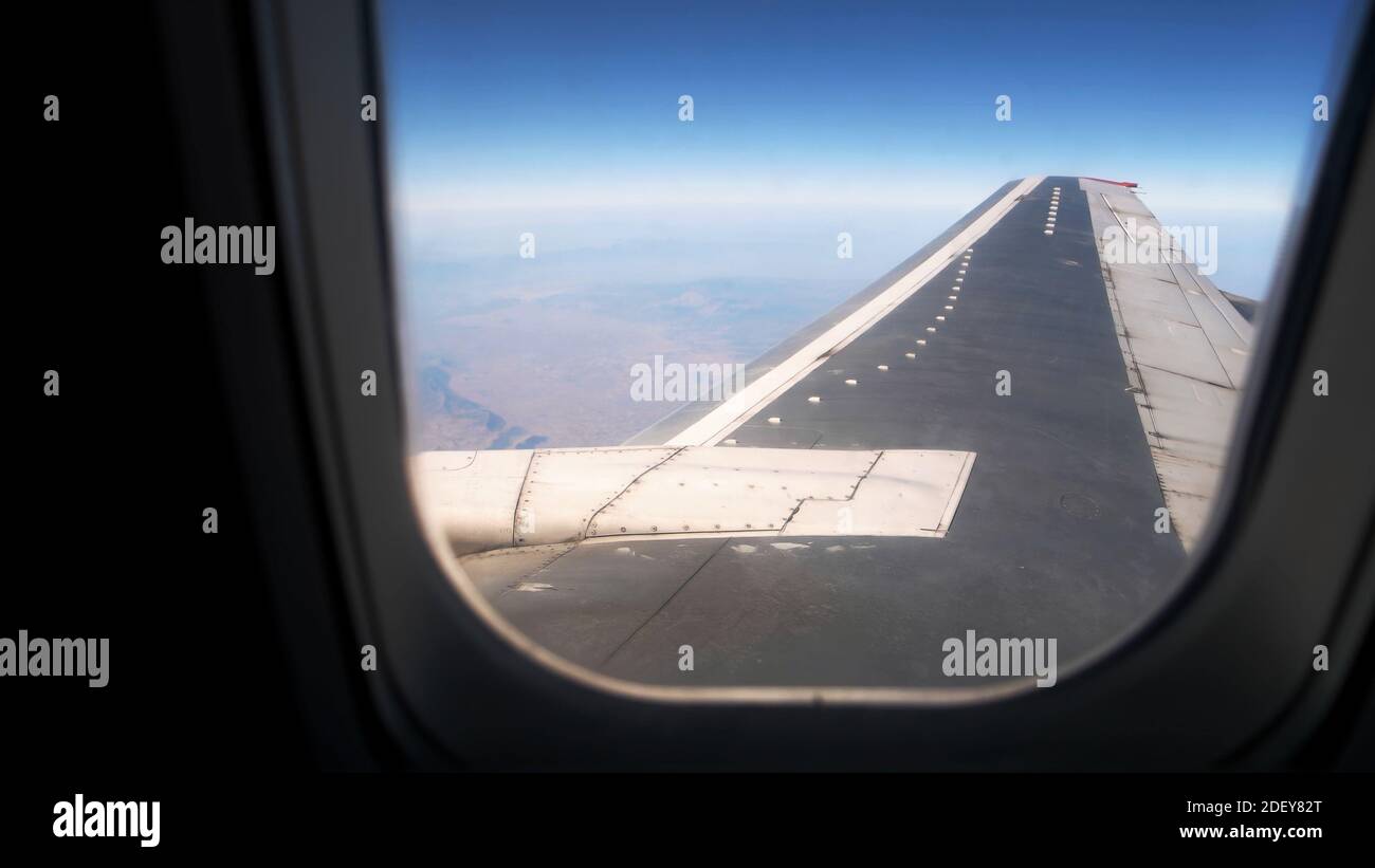 View of plane wing from airplane window Stock Photo - Alamy