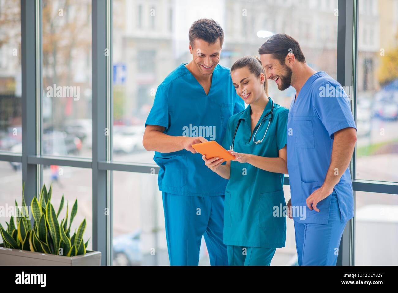 Medical team working together watching hi-res stock photography and ...