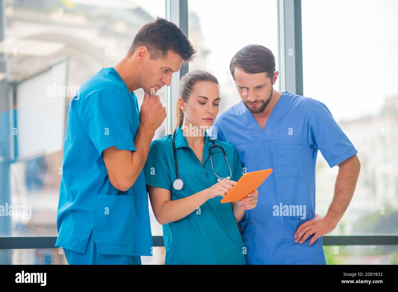 Medical team working together watching hi-res stock photography and ...