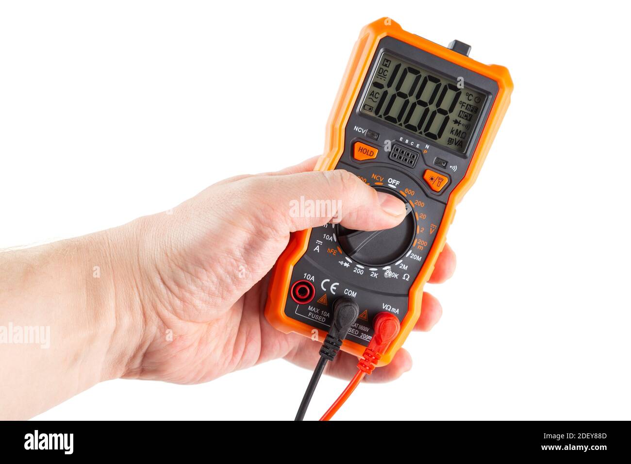 lcd screen digital electrical multimeter in left hand, isolated on ...