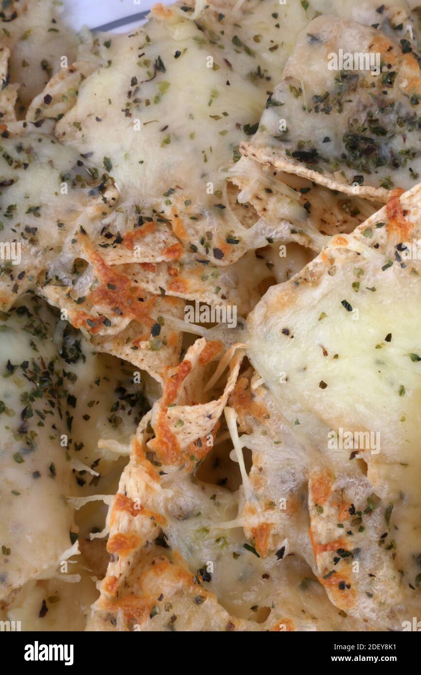 triangle nachos with hot cheese sauce as snack mexican food Stock Photo ...