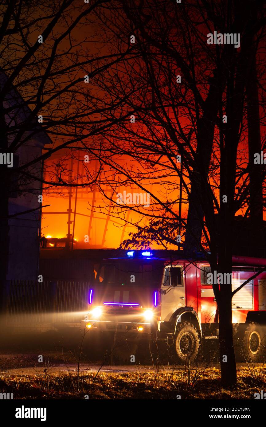 Fire in factory building at night. Burned by fire industrial warehouse ...