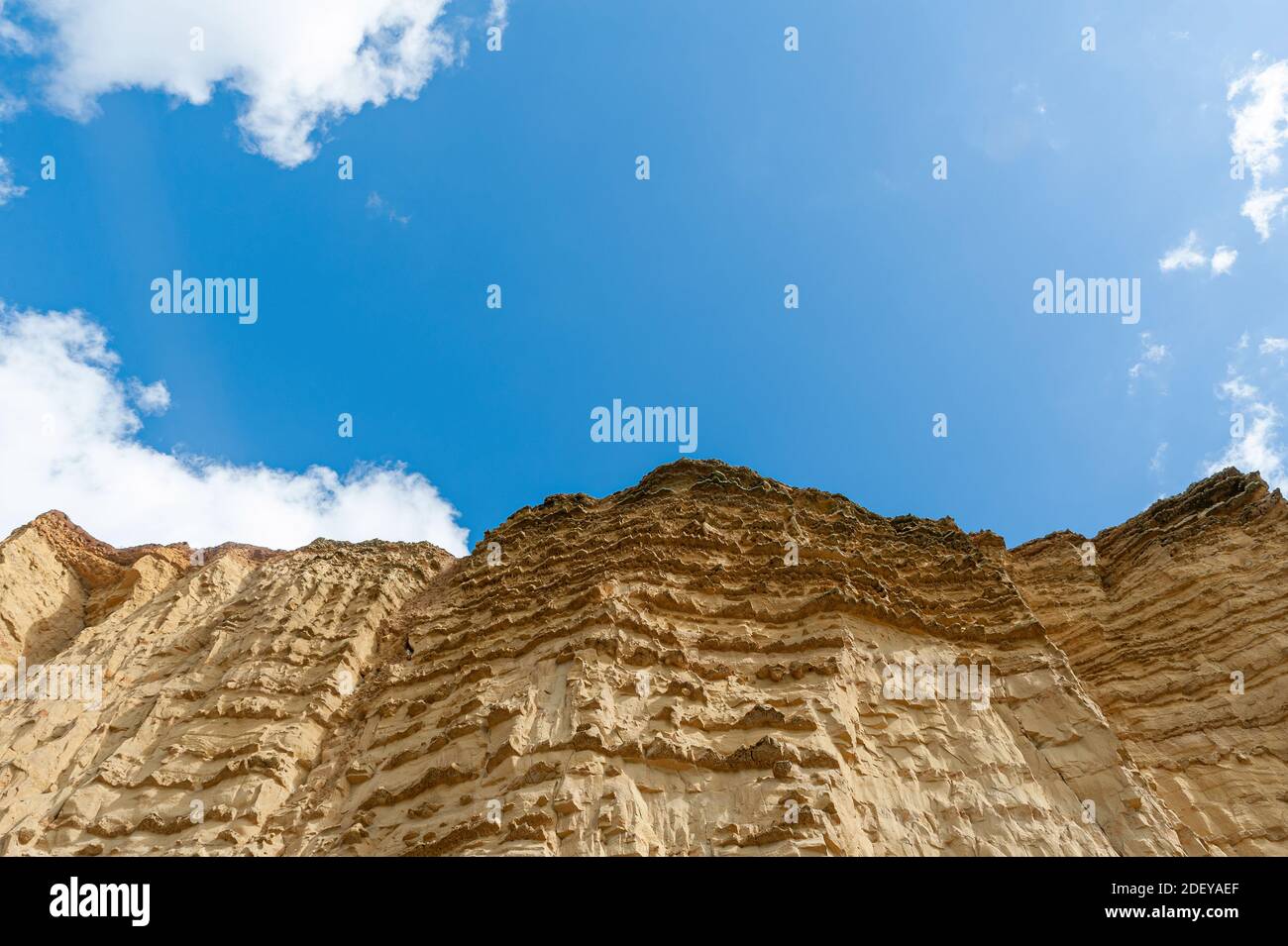 The imposing and eroded sandstone cliffs exposing millions of years of ...
