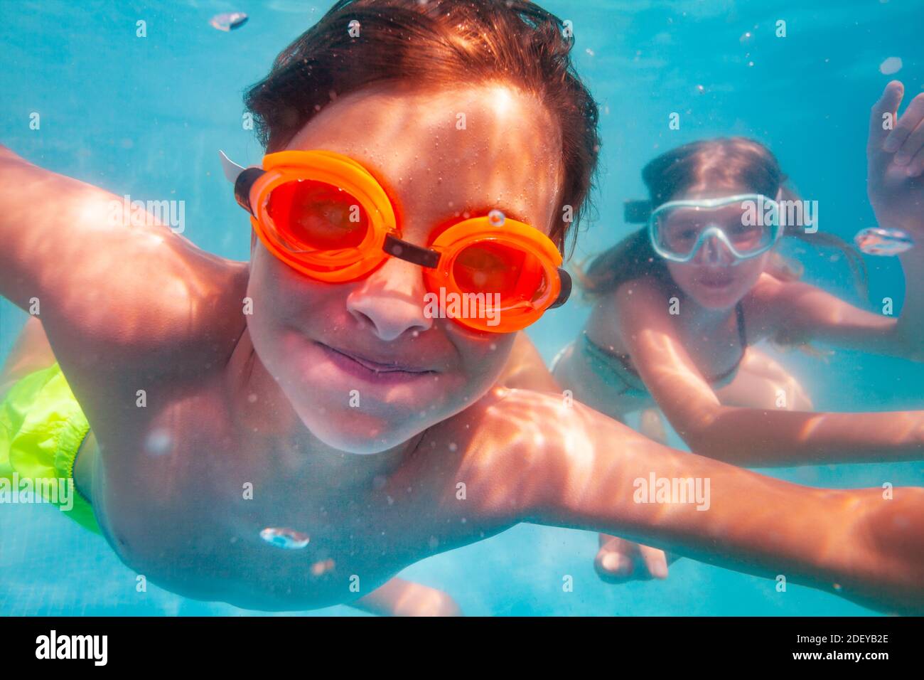 Friends swimming underwater together hi-res stock photography and ...