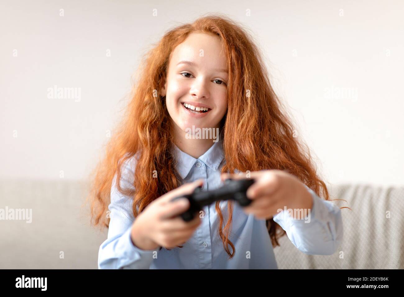 Young girl playing a video game with controller Stock Photo - Alamy