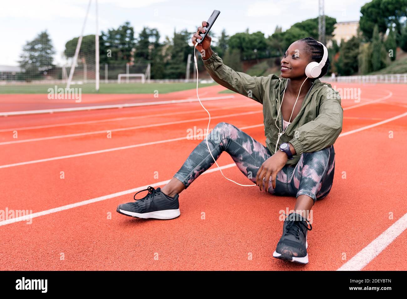 Stock photo of an African-American sprinter sitting on the athletics ...