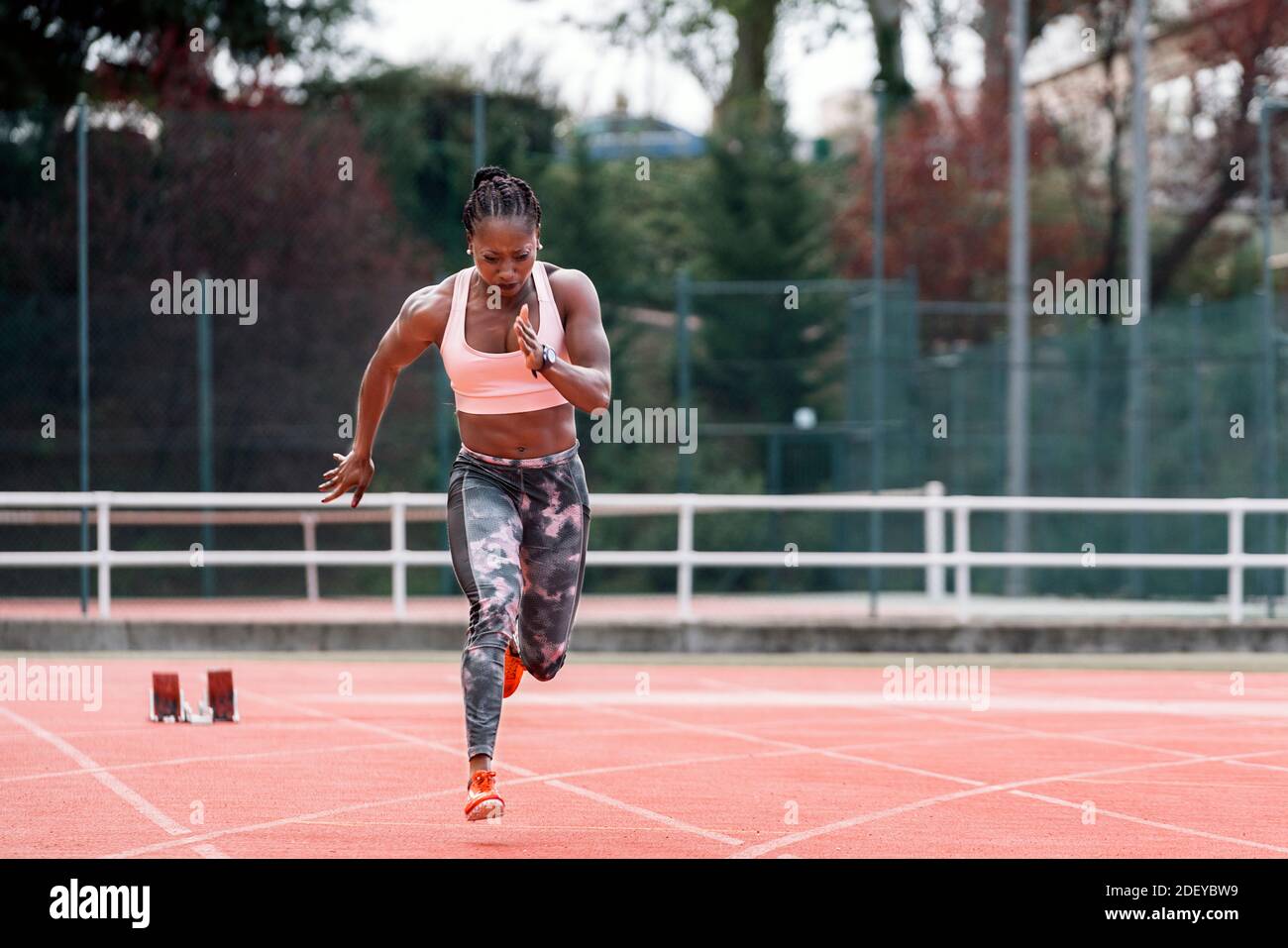 Stock photo of an African-American sprinter running on an athletics ...