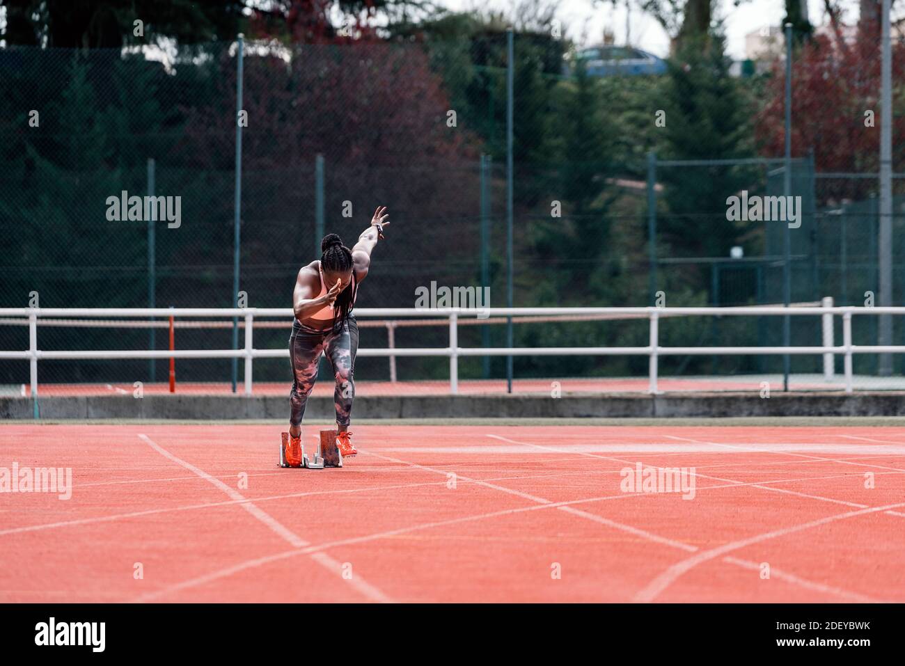Stock photo of an African-American sprinter running on an athletics ...