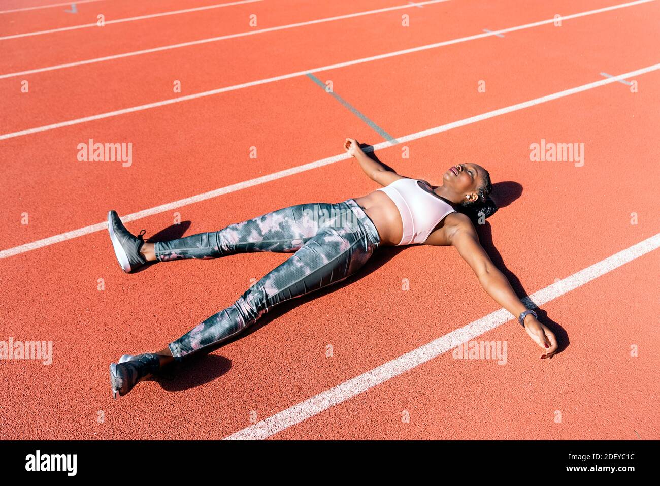 Stock photo of an African-American sprinter lying down on an athletics ...
