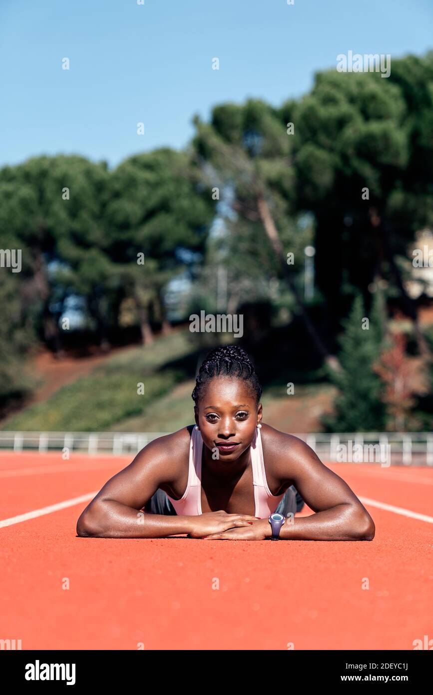 Stock photo of an African-American sprinter lying down on an athletics ...