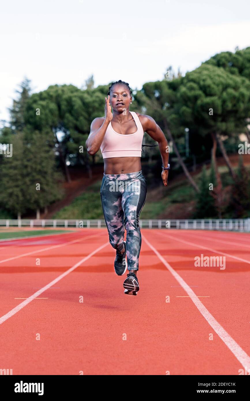 Stock photo of a front view of an African-American sprinter running on ...