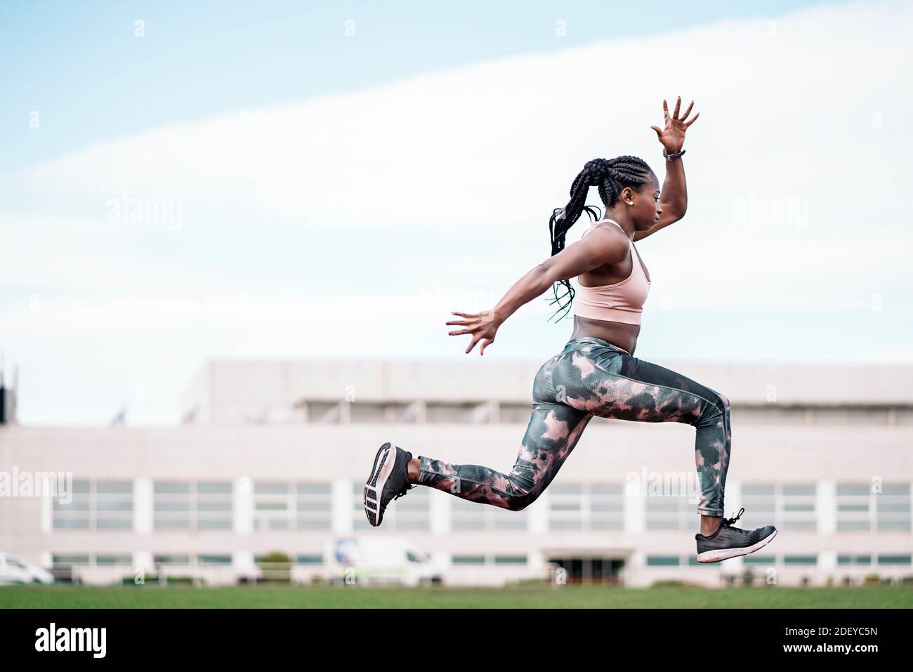 Stock photo of an African-American sprinter jumping in the sports ...