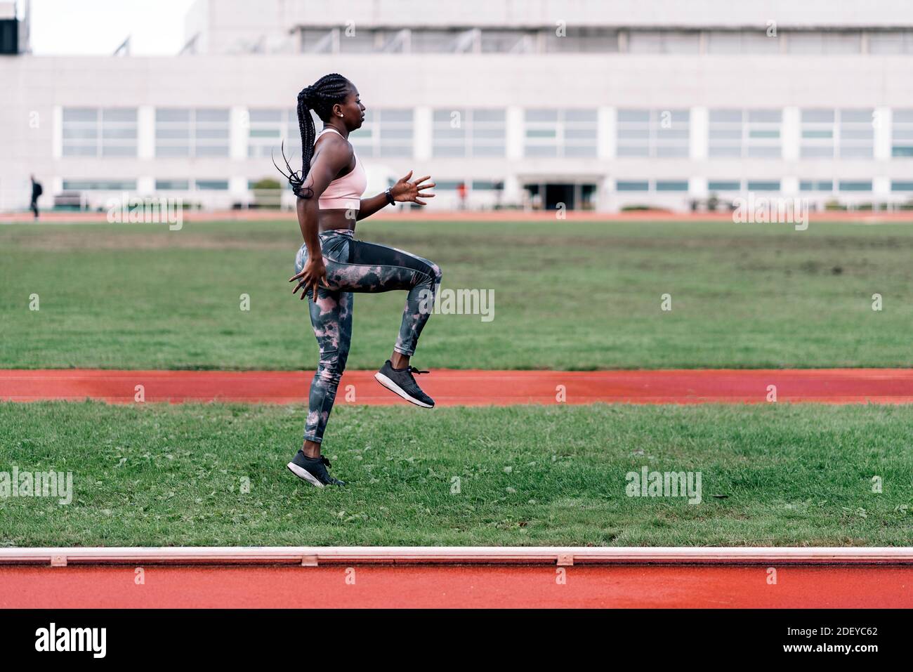 Stock photo of an African-American sprinter jumping and warming up in ...