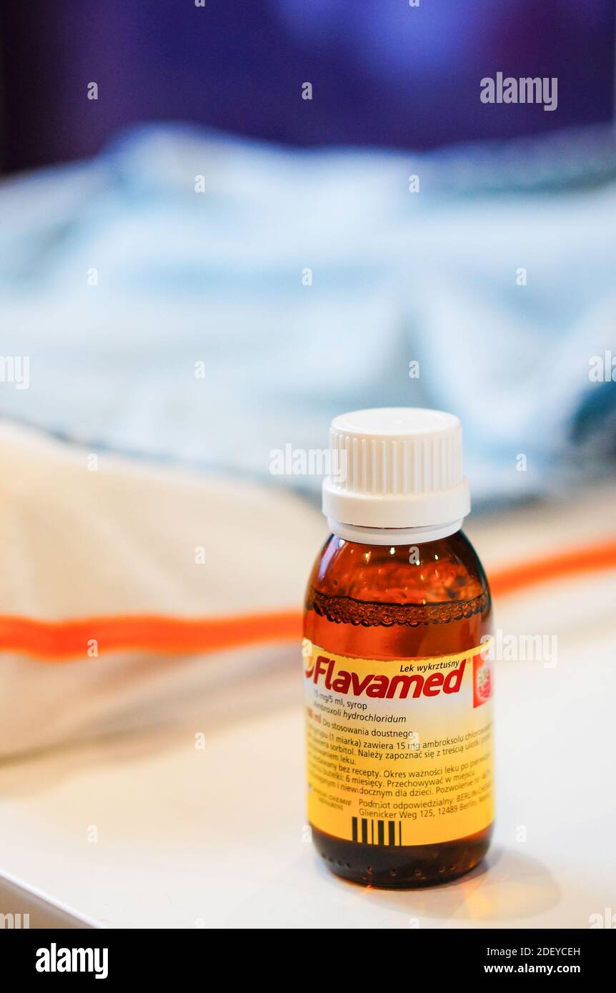 A selective focus vertical shot of a syrup medicine in a small bottle ...