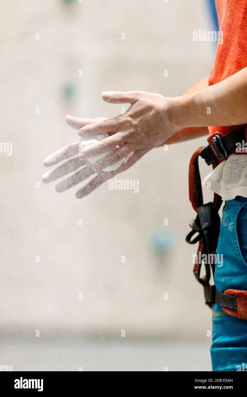Stock photo of an adult woman chalking her hands before rock climbing ...
