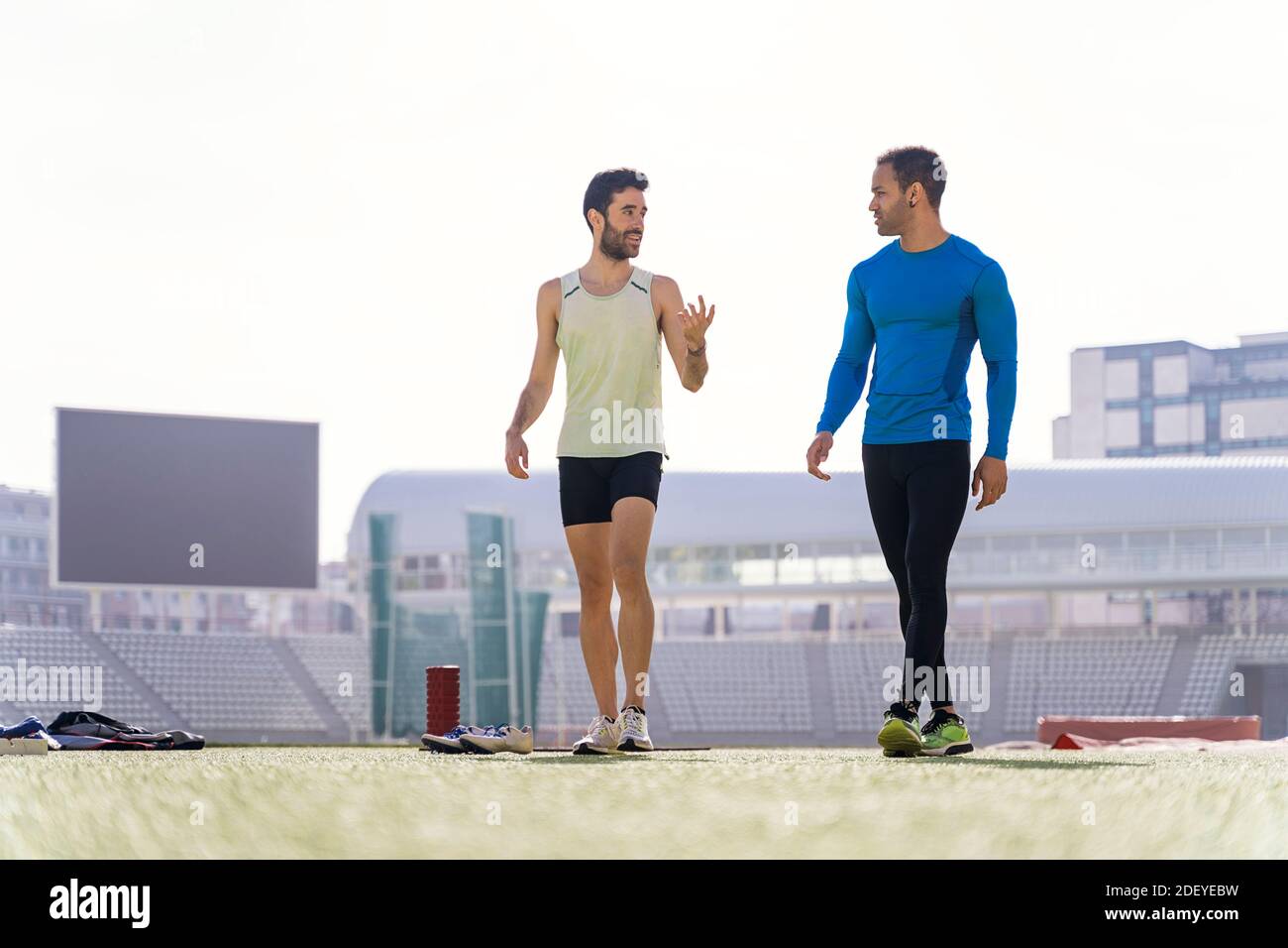 Stock photo of two friends athletes wearing sports clothes chatting and ...