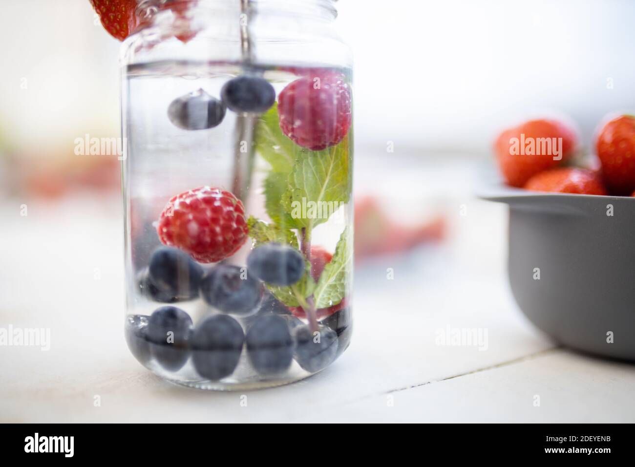 Raspberry, blueberry, and mint drink inside a jar Stock Photo - Alamy