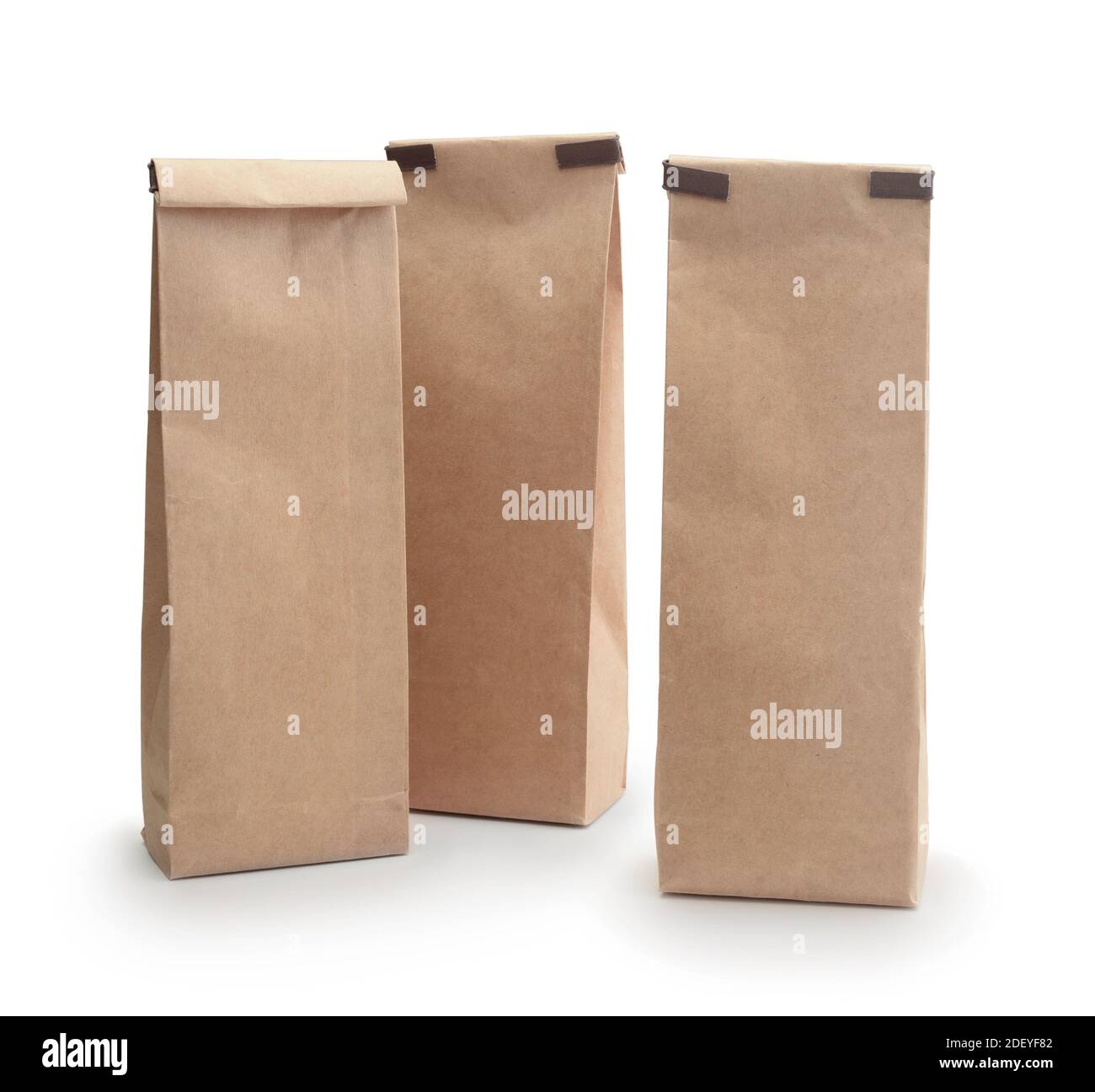 Group of paper craft disposable bags isolated on white Stock Photo - Alamy