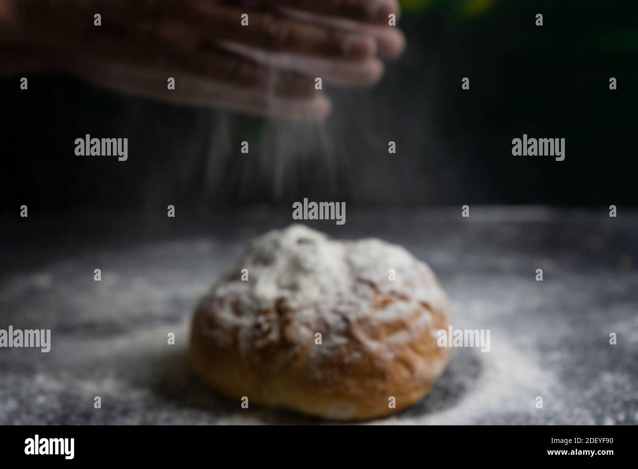 Blurred cooking bread concept, flour splash with hands on tradicional ...
