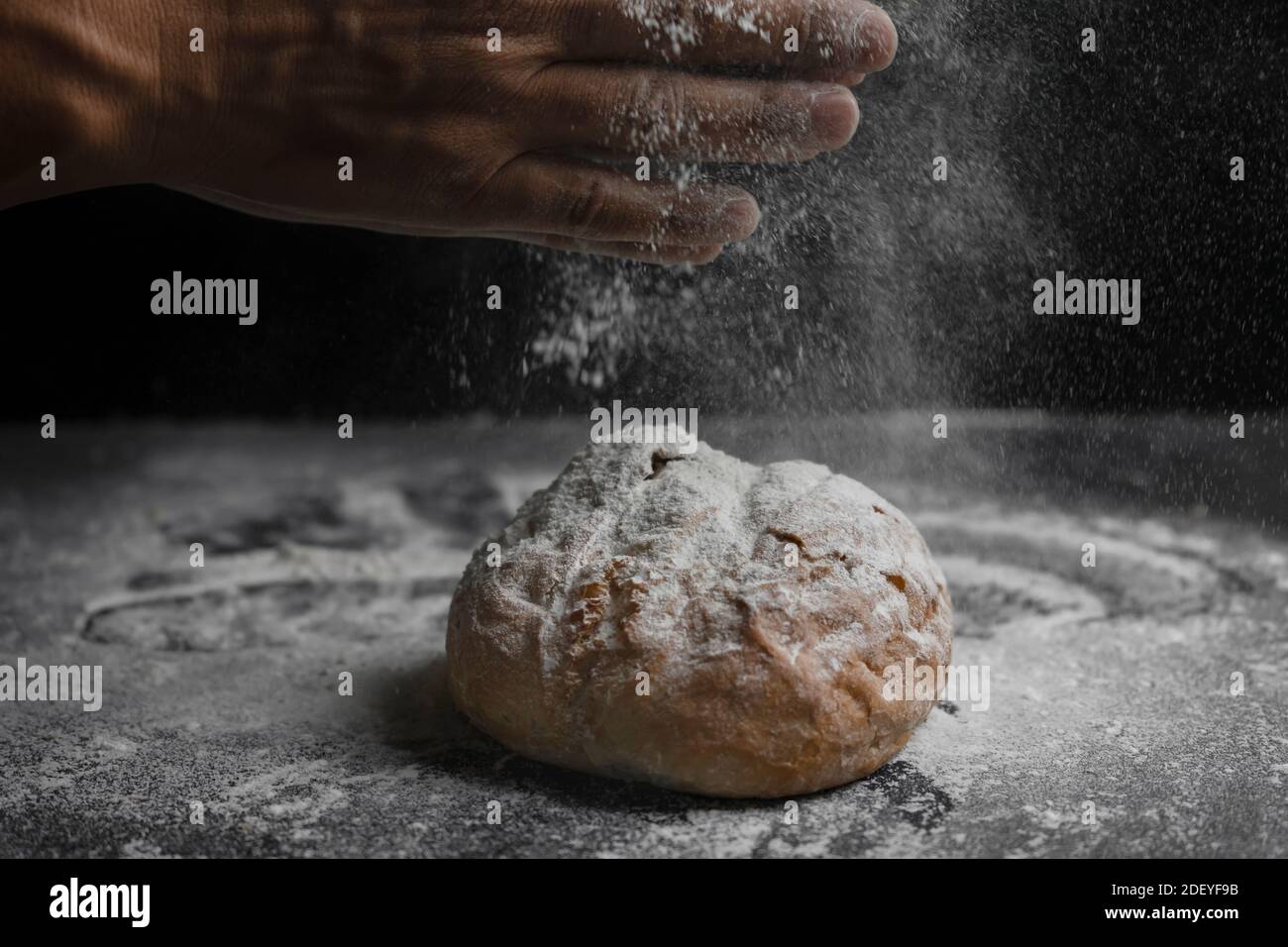 Baker clap hands with flour splash on fresh bread.Bakery concept ...