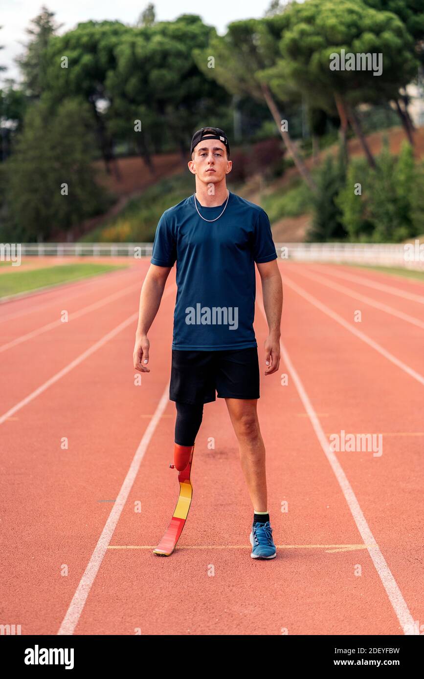 Stock photo of disabled man athlete standing in the running track and ...