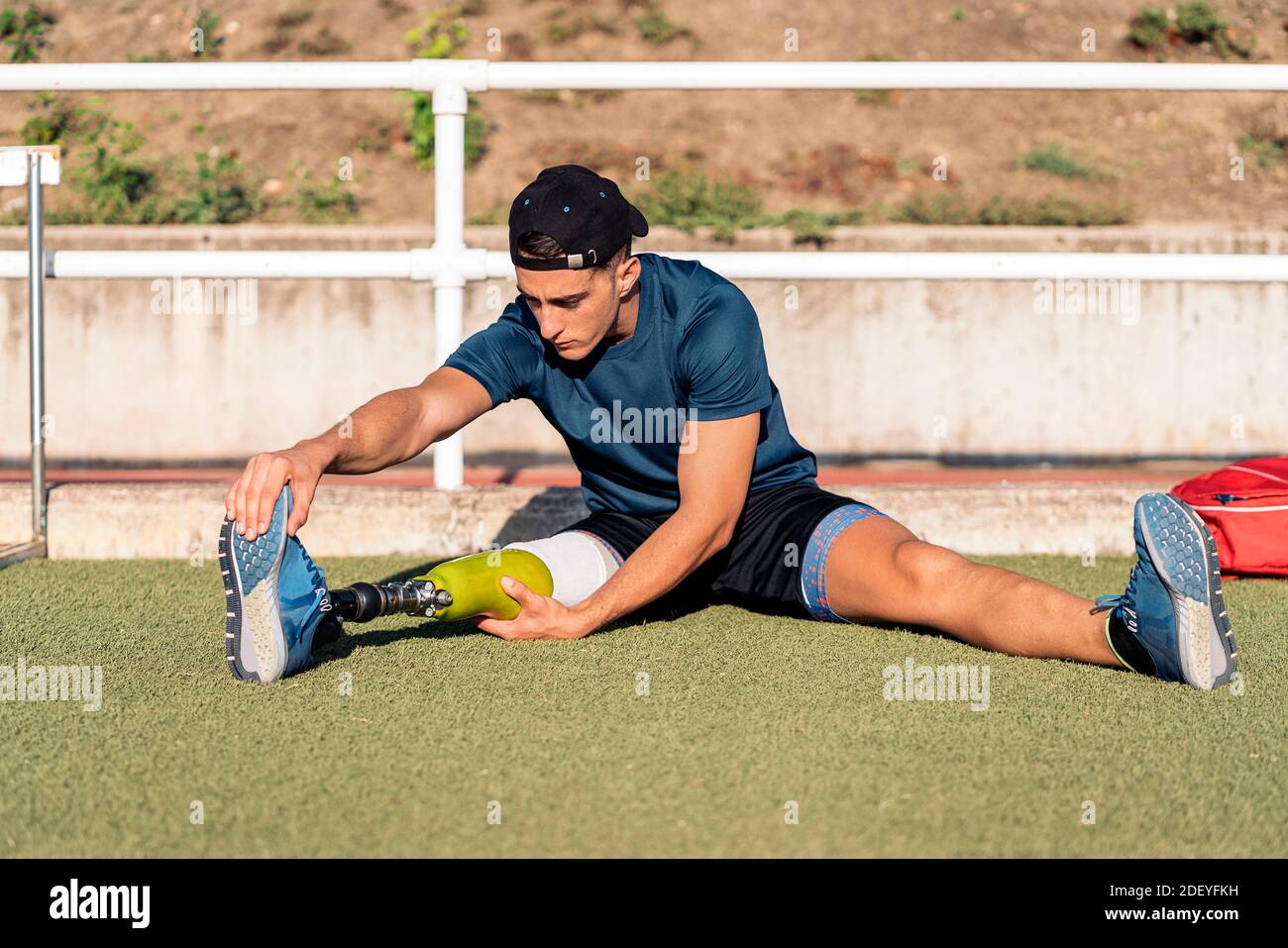 Disabled man athlete stretching with leg prosthesis. Paralympic Sport ...
