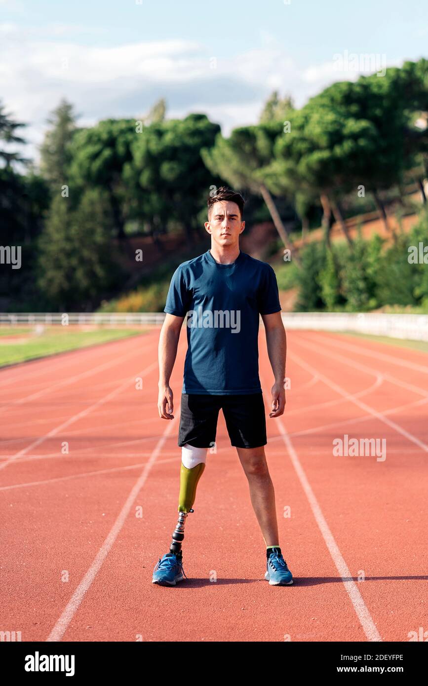 Stock photo of disabled man athlete standing in the running track and ...