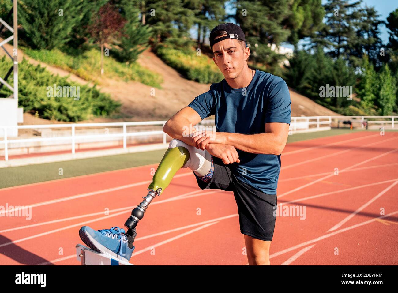 Stock photo of disabled man athlete standing in the running track and ...