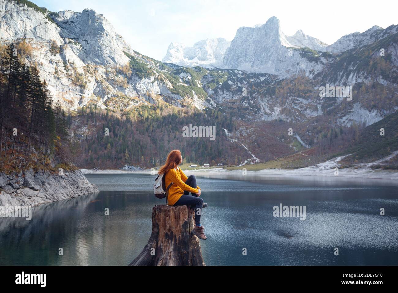 beautiful girl sits on a stump and smiling at the camera on a ...